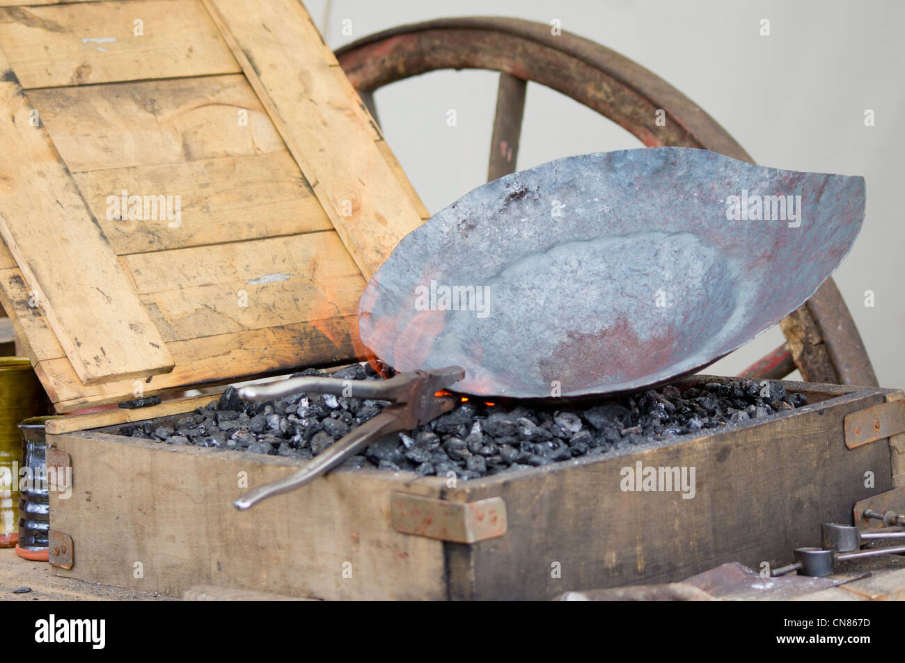 Demonstrating medieval blacksmithing. Making a helmet on a mobile forge ...