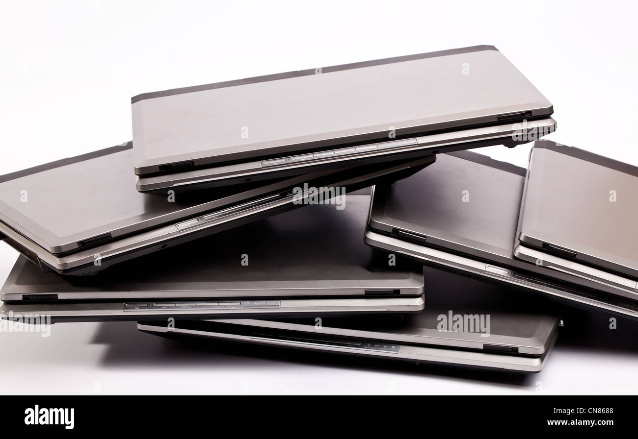 Pile of laptops on the white background Stock Photo - Alamy