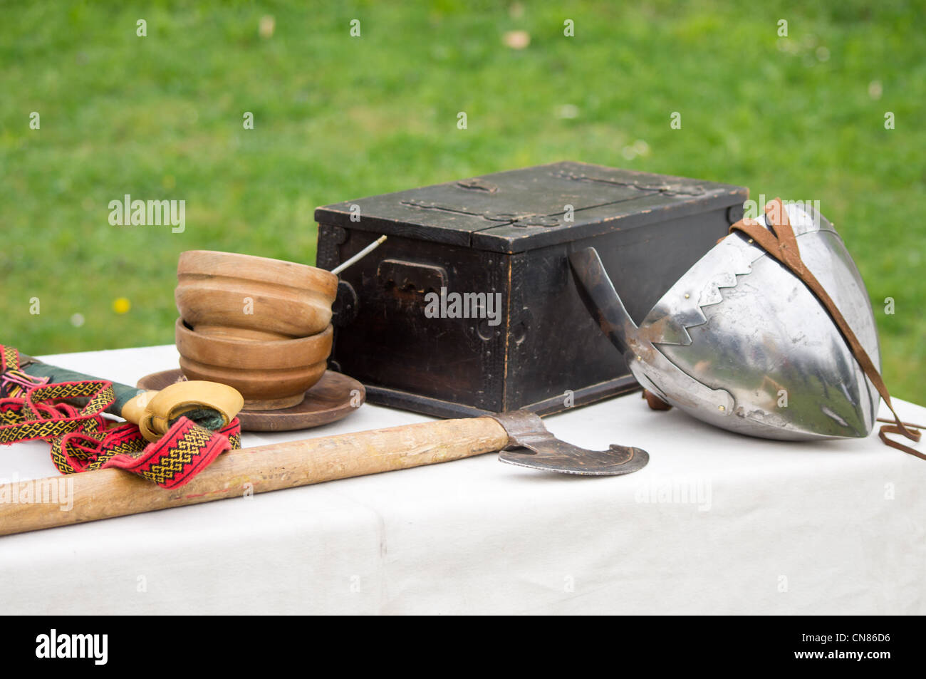Still life picture of medieval items on a table including an Axe ...