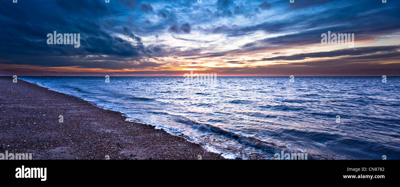 Winter sunset over the Wash showing brightly coloured cloud patterns ...