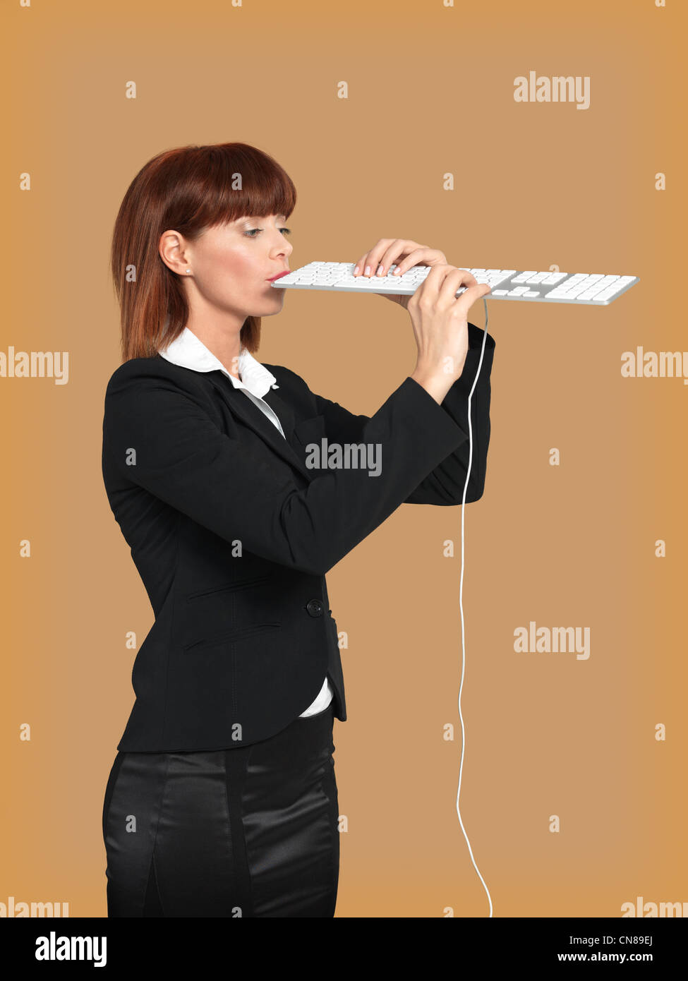 funny portrait of a young businesswoman, playing and singing on a ...