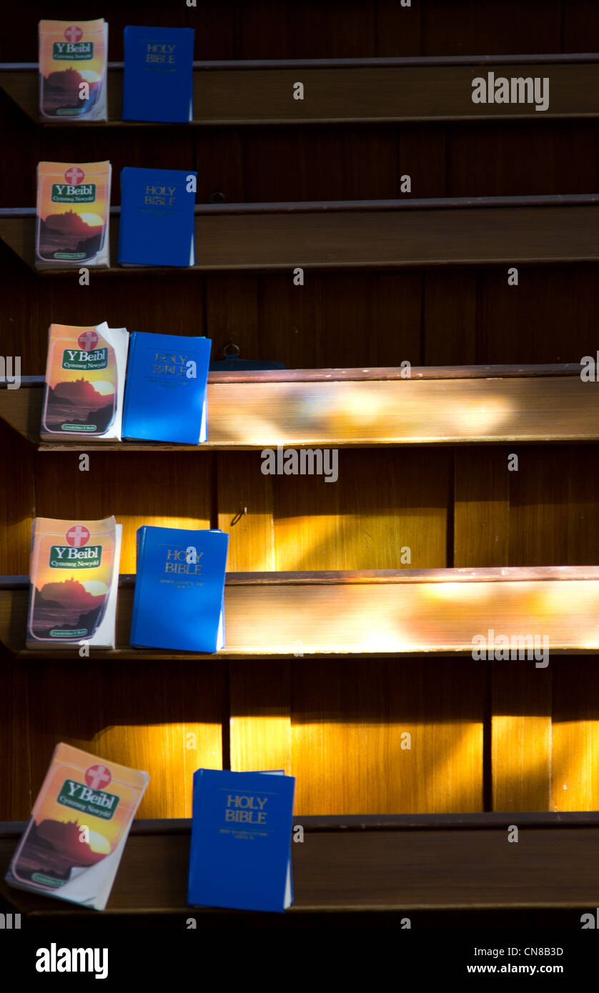 Holy Bible and Beibl Cymraeg laid out on sunny pews at a mid-Wales ...
