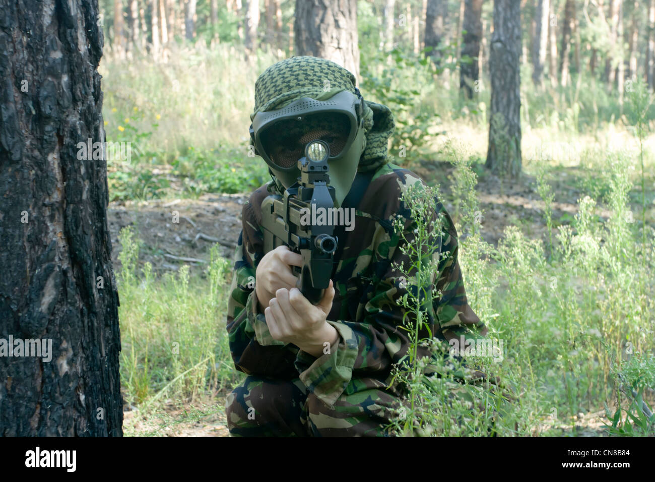 Airsoft player aiming a pistol at a target Stock Photo - Alamy