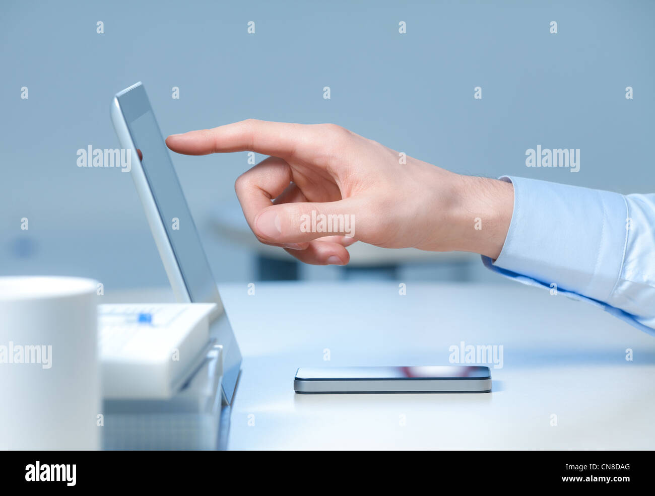 Hand pointing on modern digital tablet pc at the workplace Stock Photo ...