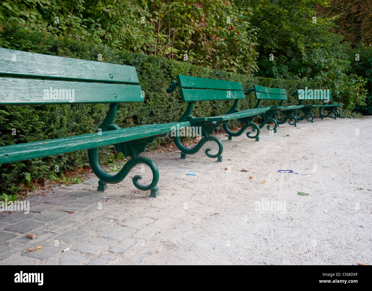 Row of green benches in Bruges park Stock Photo - Alamy
