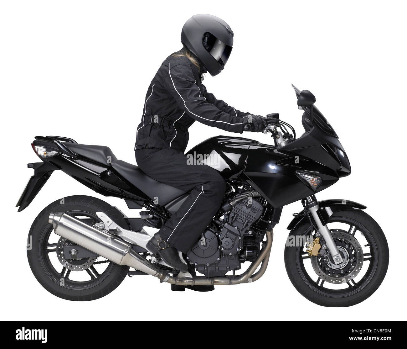 sideways shot of a motorbike with driving biker in white back Stock ...