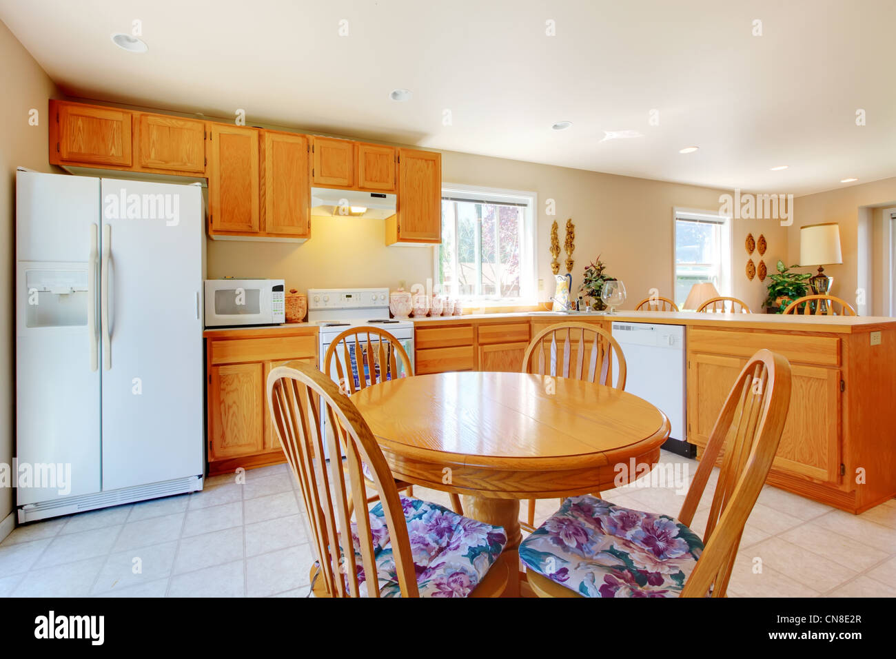 Simple kitchen with table and white appliances Stock Photo - Alamy