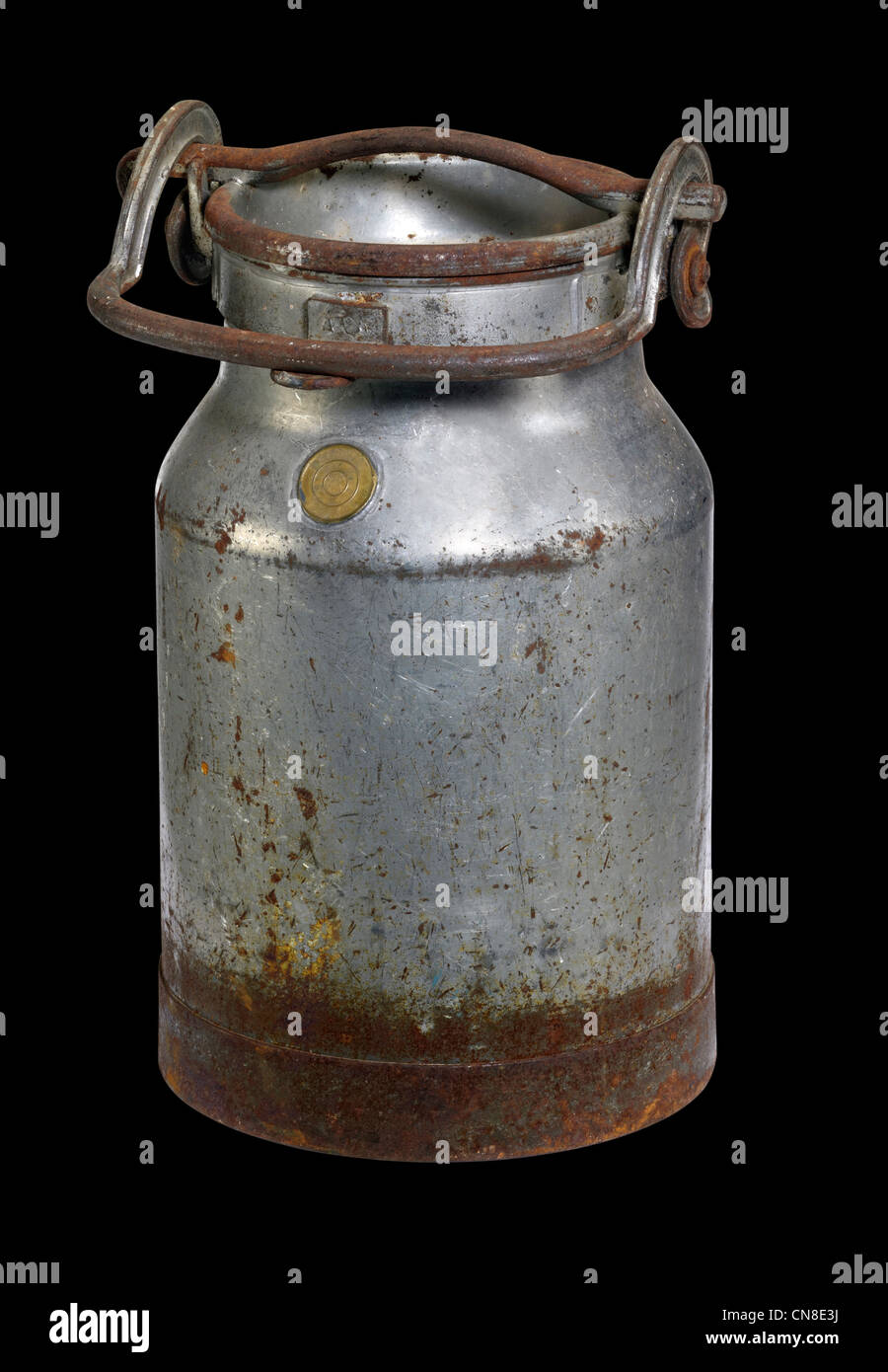 old nostalgic and corroded milk can with cap in black back Stock Photo ...