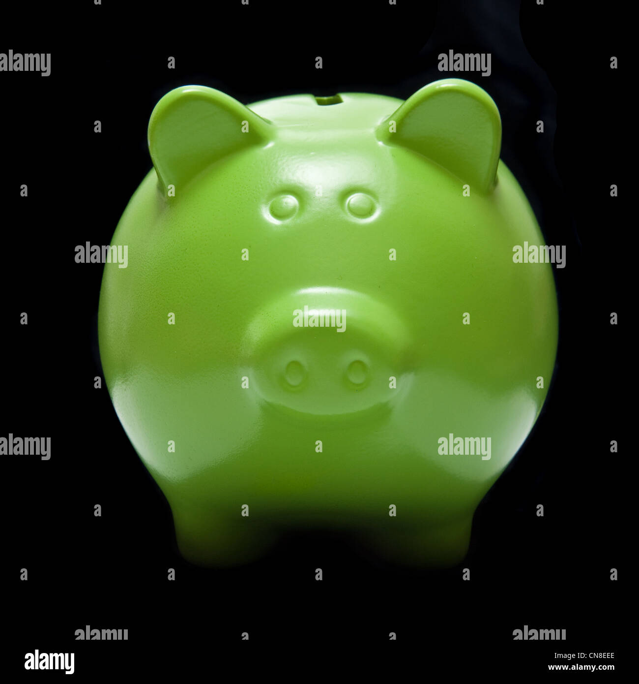 Green piggy bank or money box on a black studio background Stock Photo ...