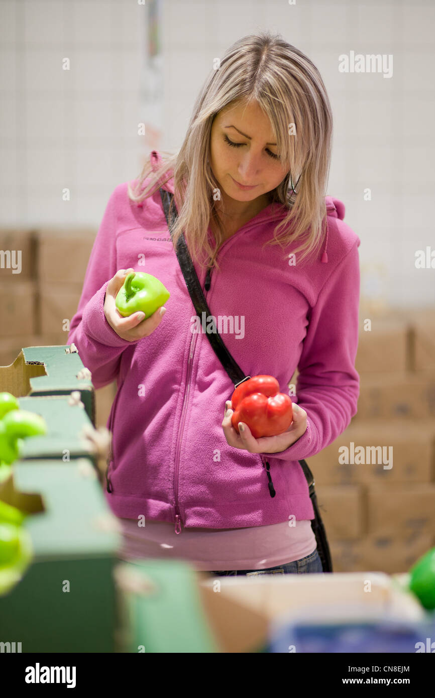 Beautiful young woman shopping for fruits and vegetables in produce ...