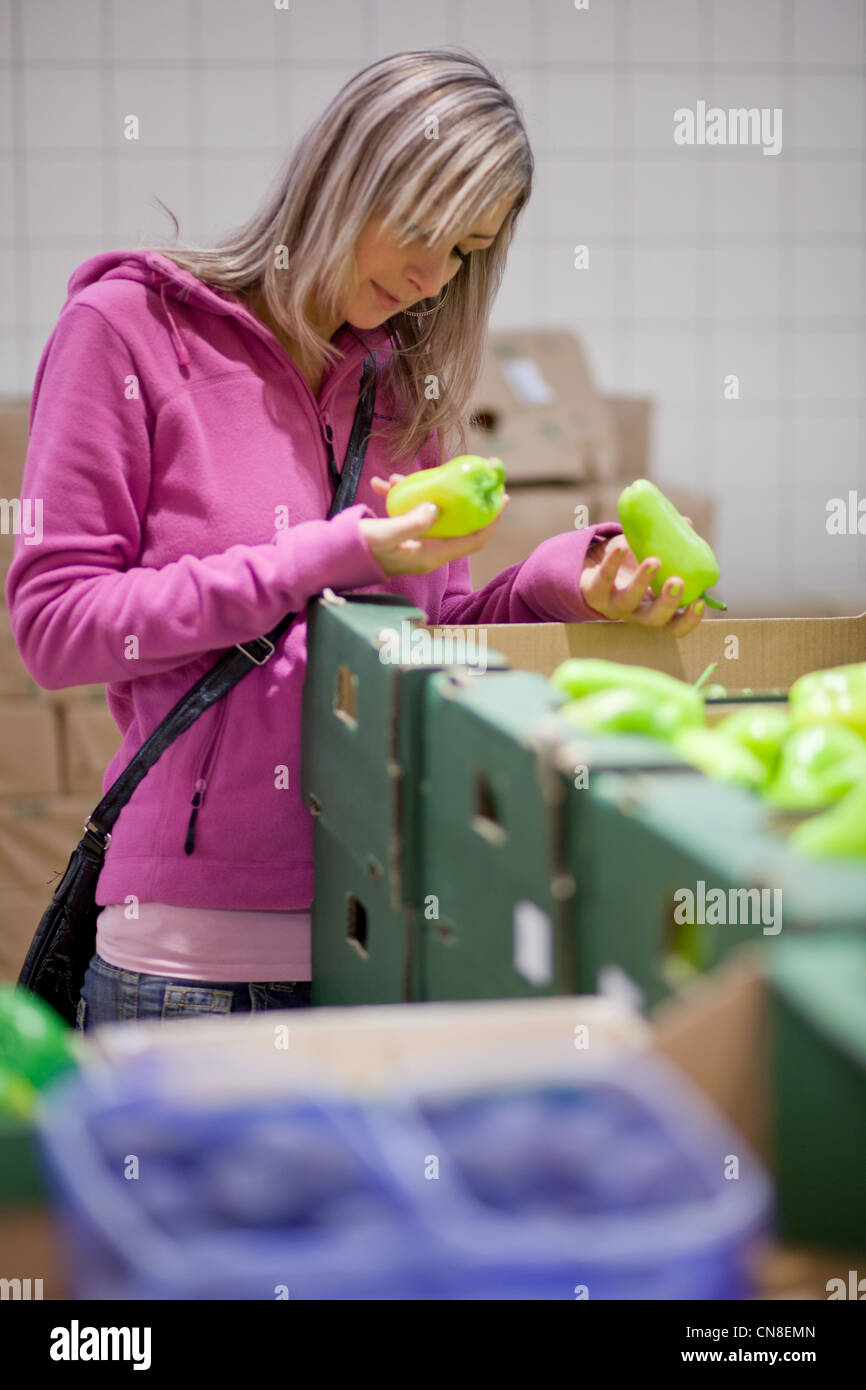 Beautiful young woman shopping for fruits and vegetables in produce ...