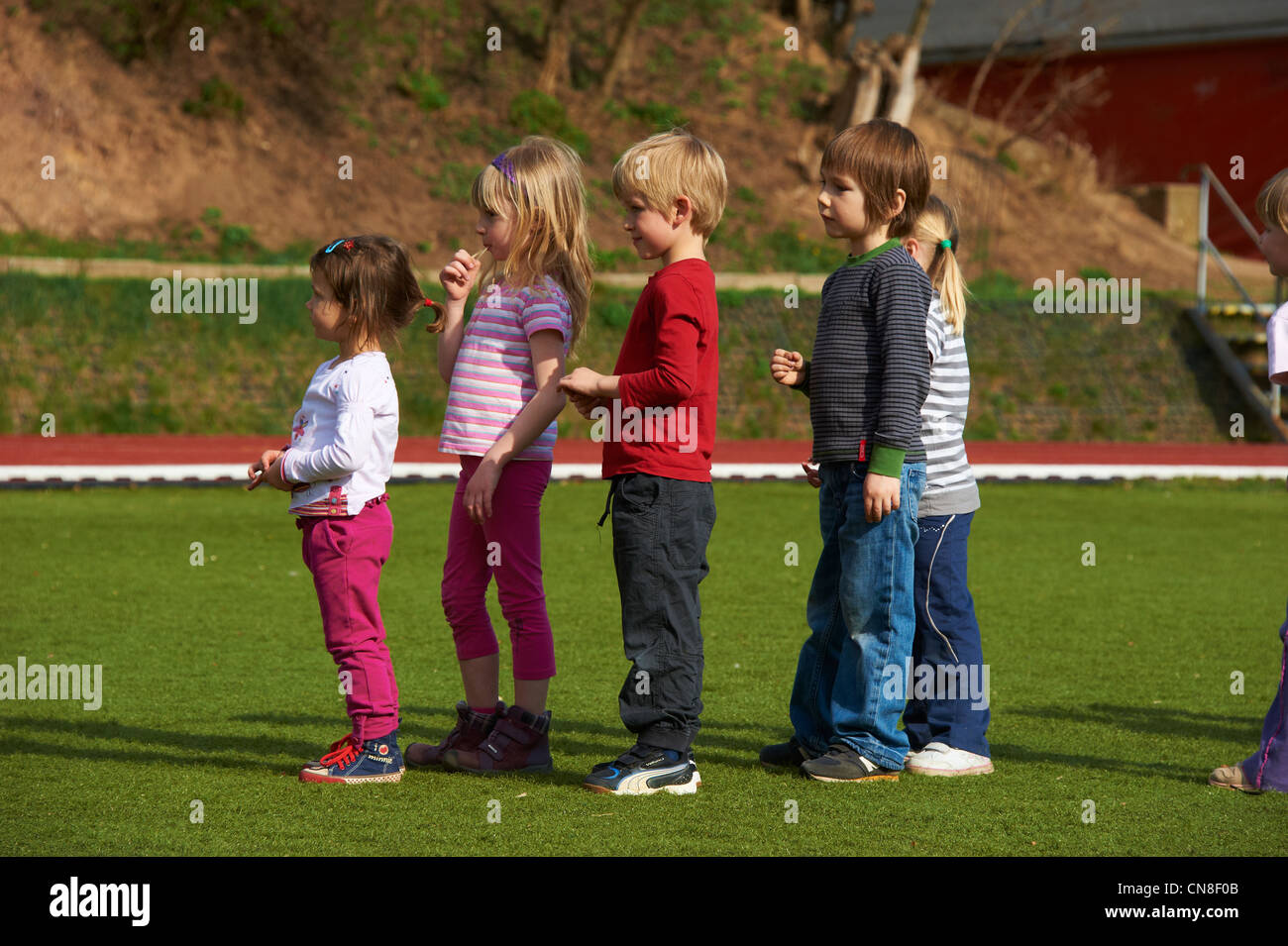 Group of preschool children do sports on sports field outside Stock ...