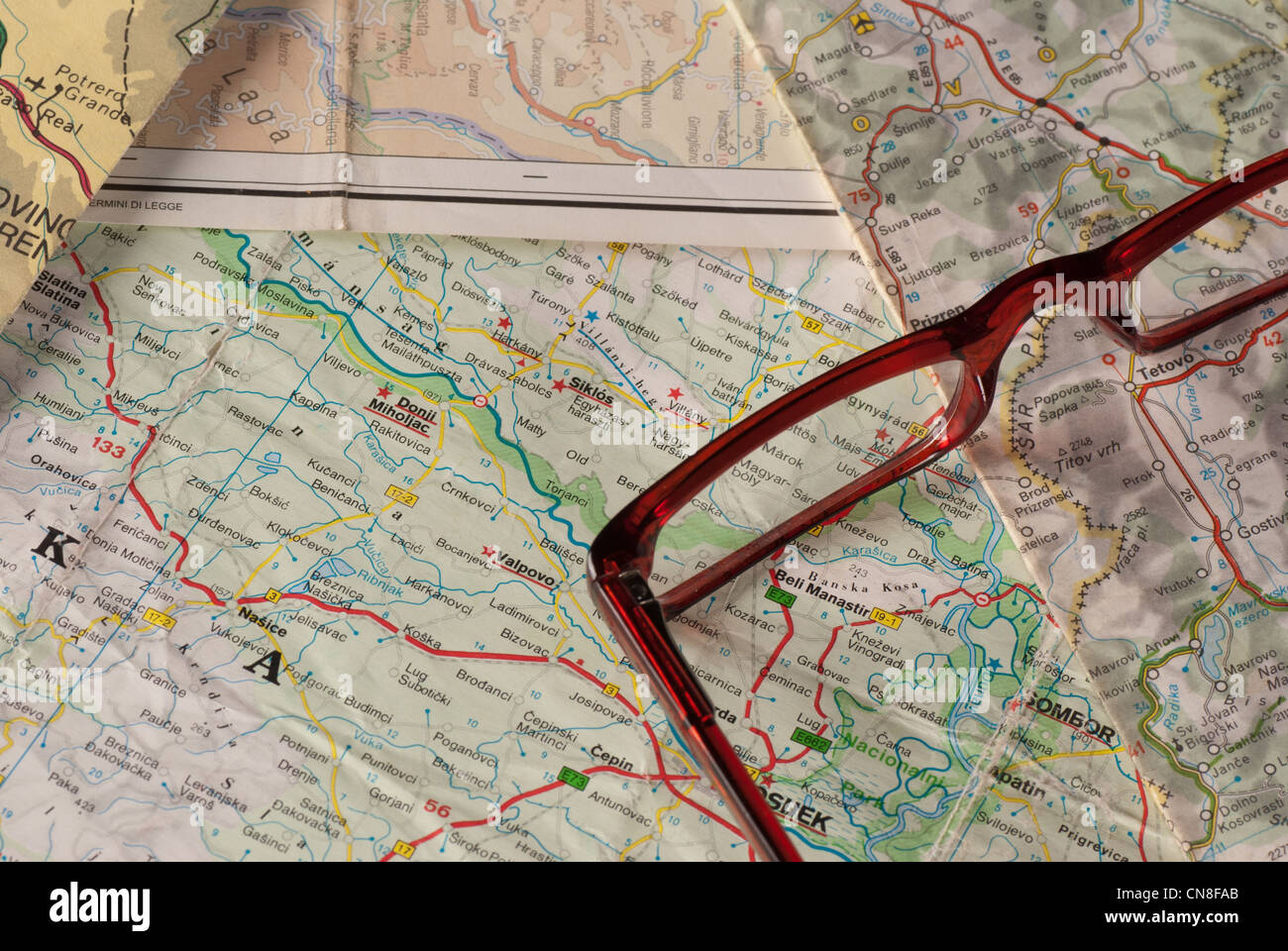 Glasses on maps, a search for directions Stock Photo - Alamy
