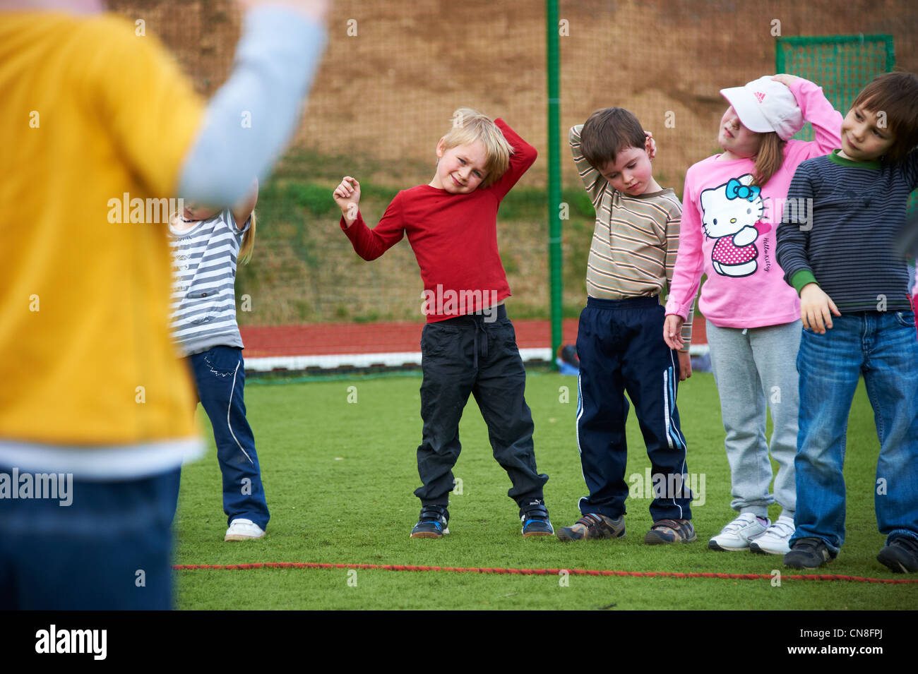 Group of preschool children do sports on sports field outside Stock ...