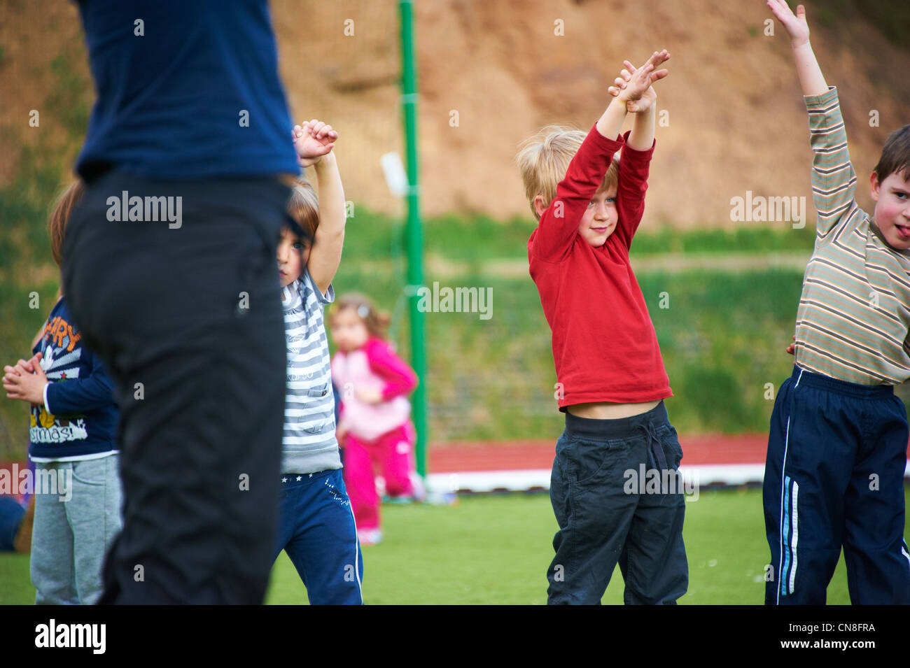 Group of preschool children do sports on sports field outside Stock ...