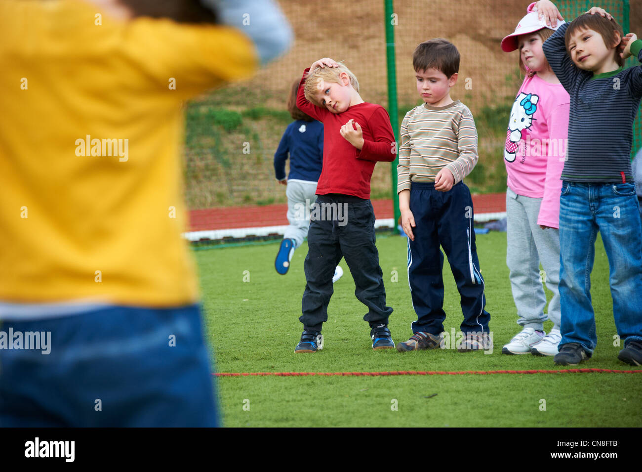 Group of preschool children do sports on sports field outside Stock ...