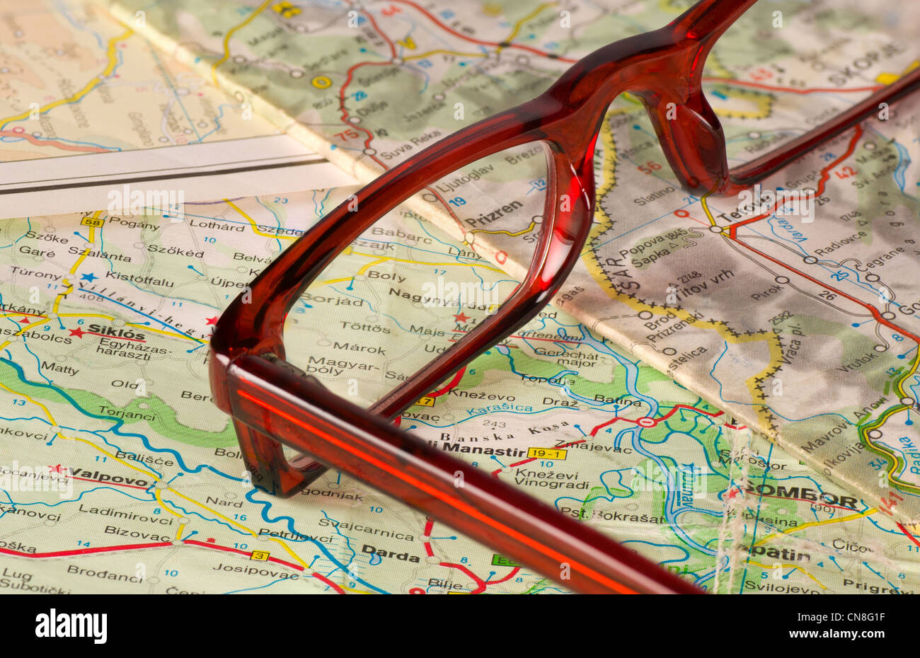 Glasses on the map, a directions concept Stock Photo - Alamy