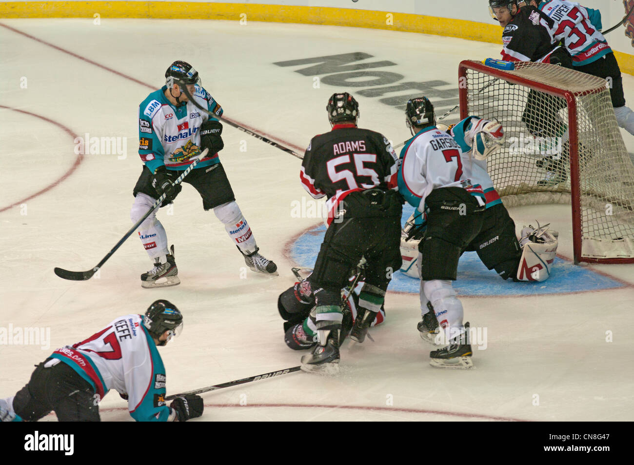 Luke Piggott, lieing on the ice, scoring Cardiff Devils 3rd goal ...