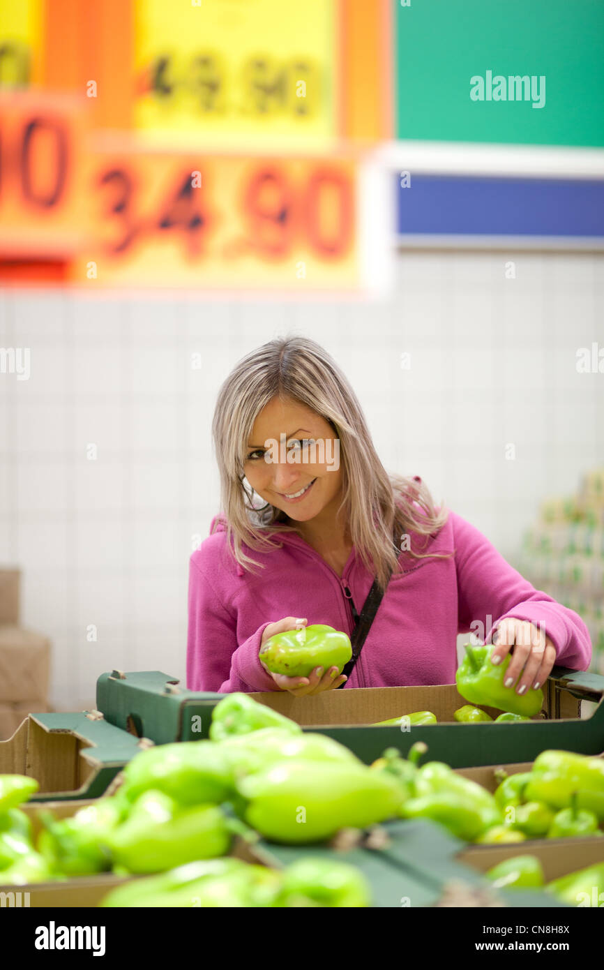Beautiful young woman shopping for fruits and vegetables in produce ...