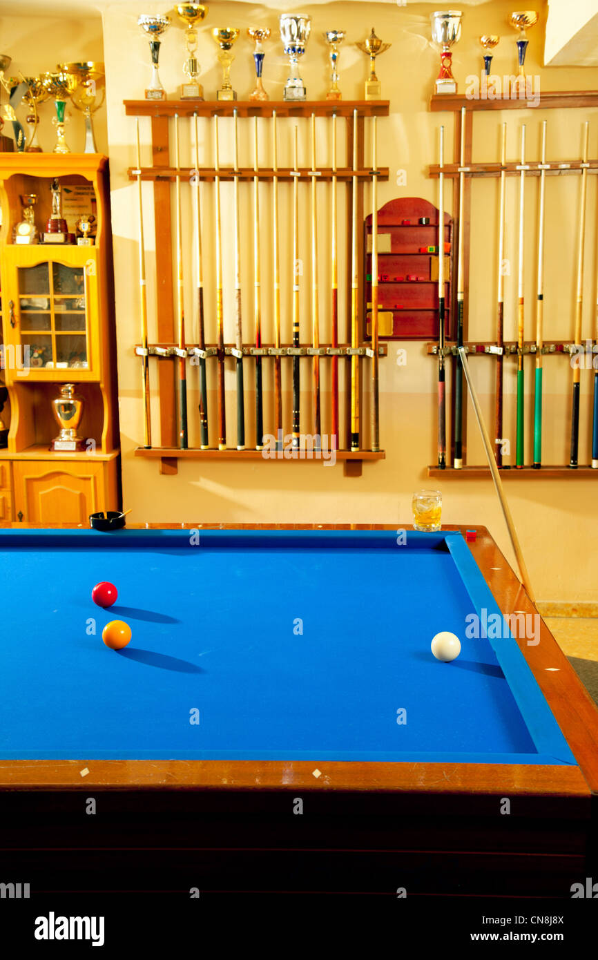 Billiard club with blue pool table cue in a row and winner trophy Stock ...