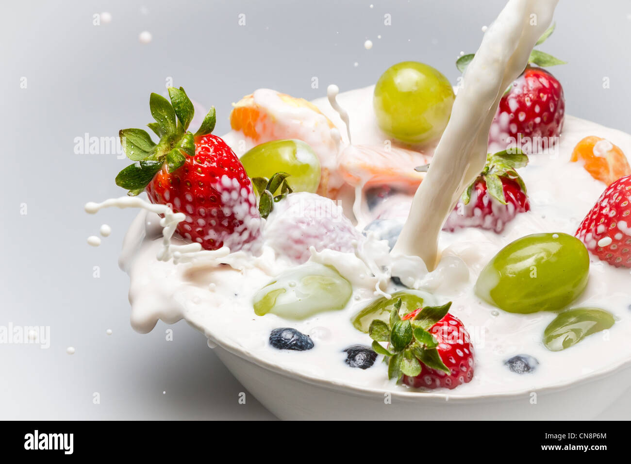 Fresh fruits and milk splash Stock Photo - Alamy