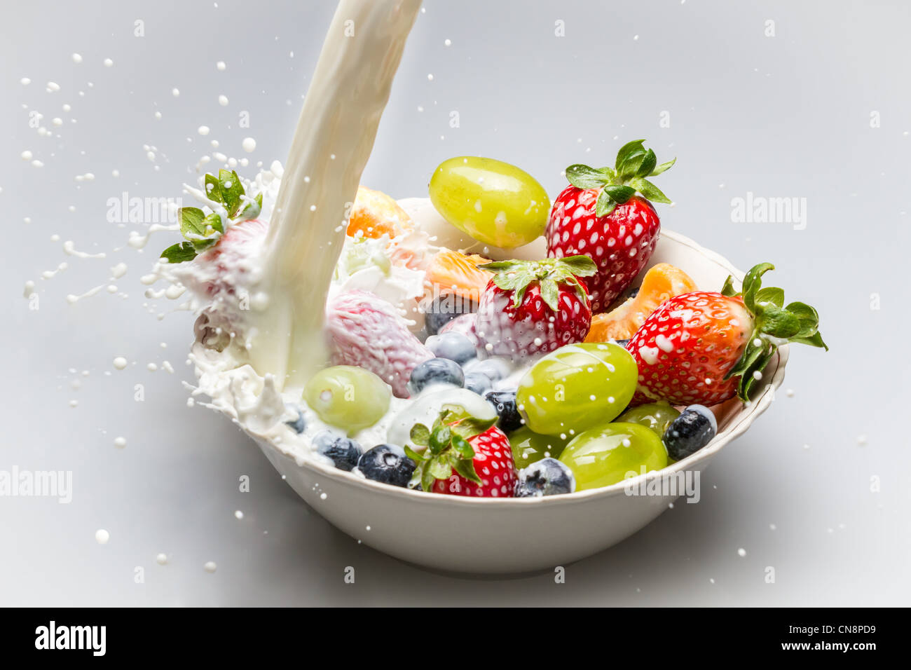 Big milk splash with fresh fruits Stock Photo - Alamy