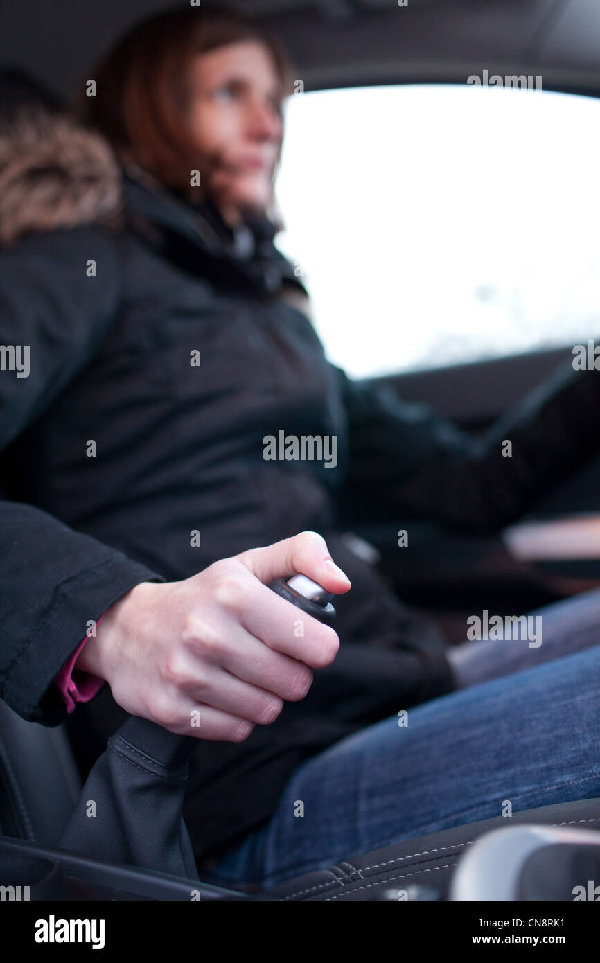 driving concept - young female driver using handbrake Stock Photo - Alamy