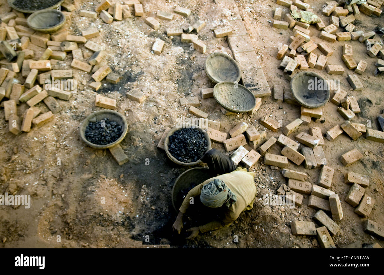 Man taking of burned coil at Fatullah brick factory , Bangladesh Stock ...