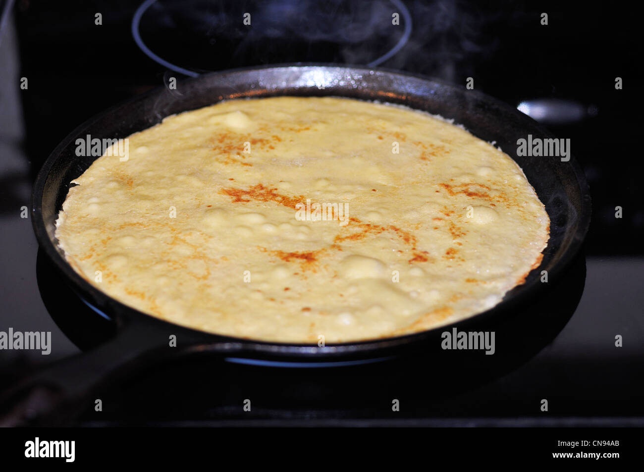 Making crepe in pan Stock Photo - Alamy