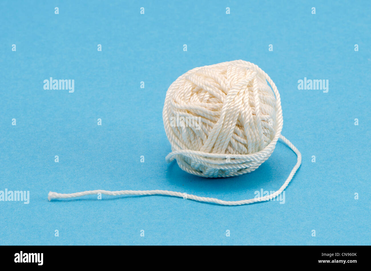white thread ball on azure background Stock Photo - Alamy