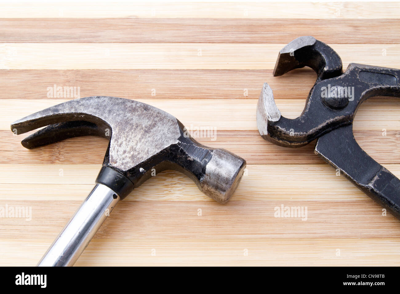 Old wrench and hammer closeup on wood background Stock Photo - Alamy