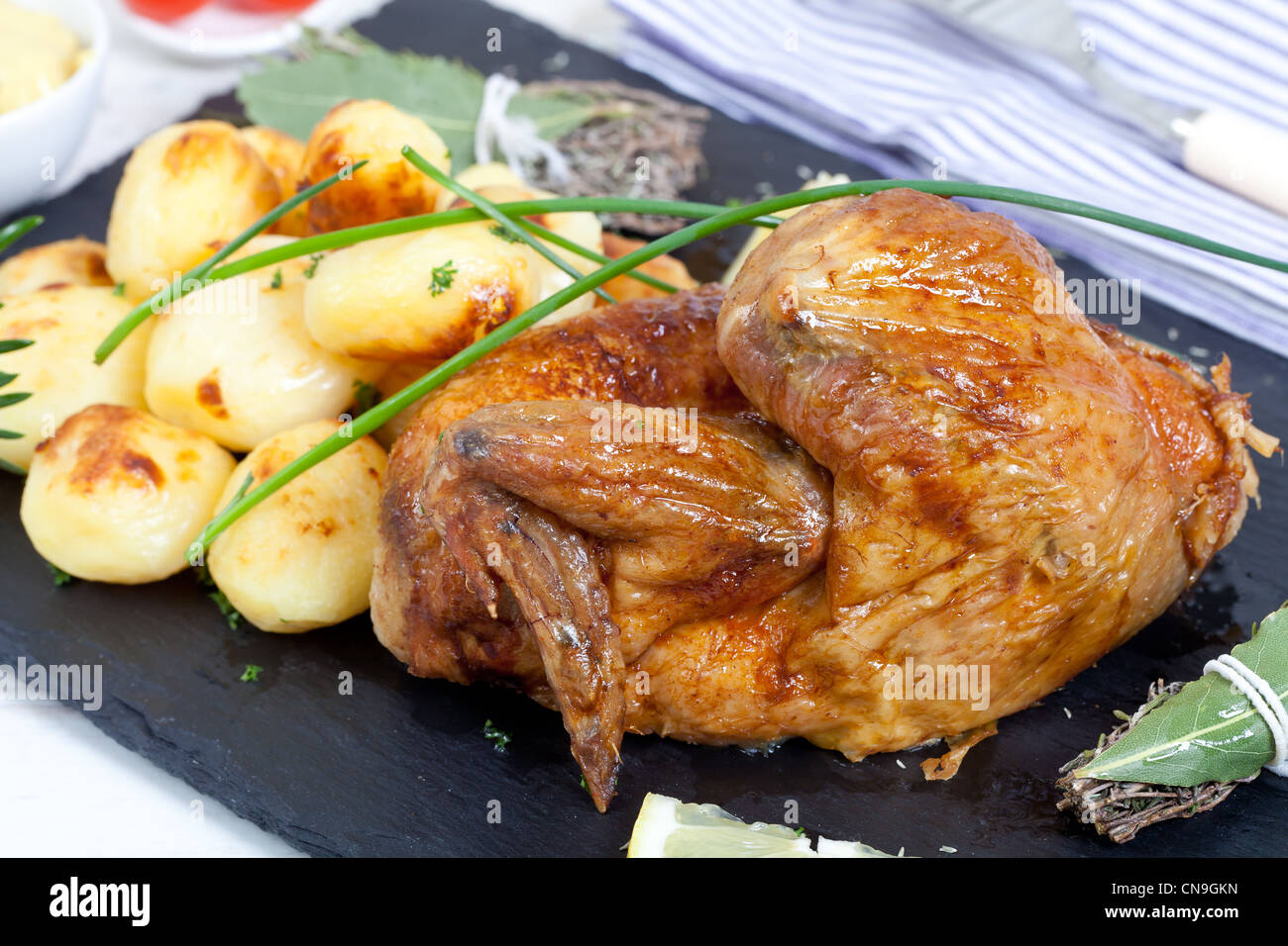 Tasty chicken with roasted potatoes Stock Photo - Alamy