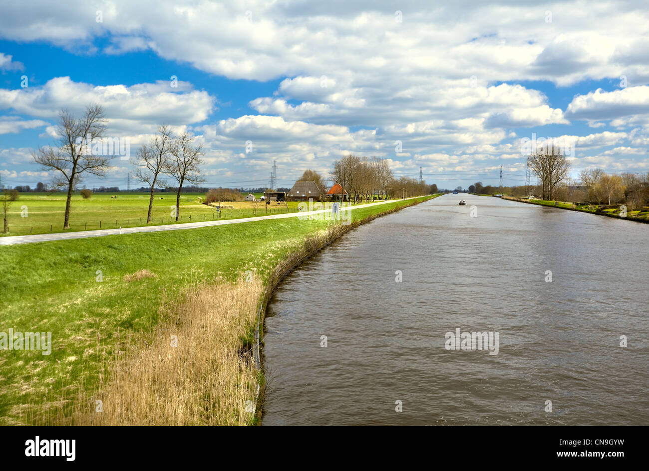 beautiful Dutch plain landscape with blue sky covered with white clouds ...