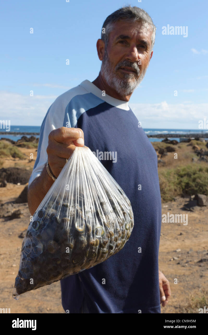 Lanzarote, Canary Islands - man with sea snails collected for eating ...