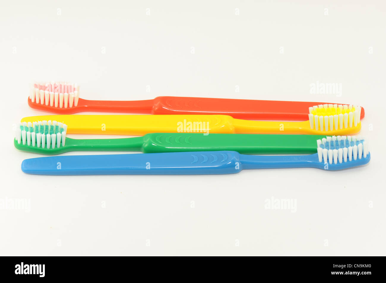 toothbrushes four colors showing bristles taken on a white background ...