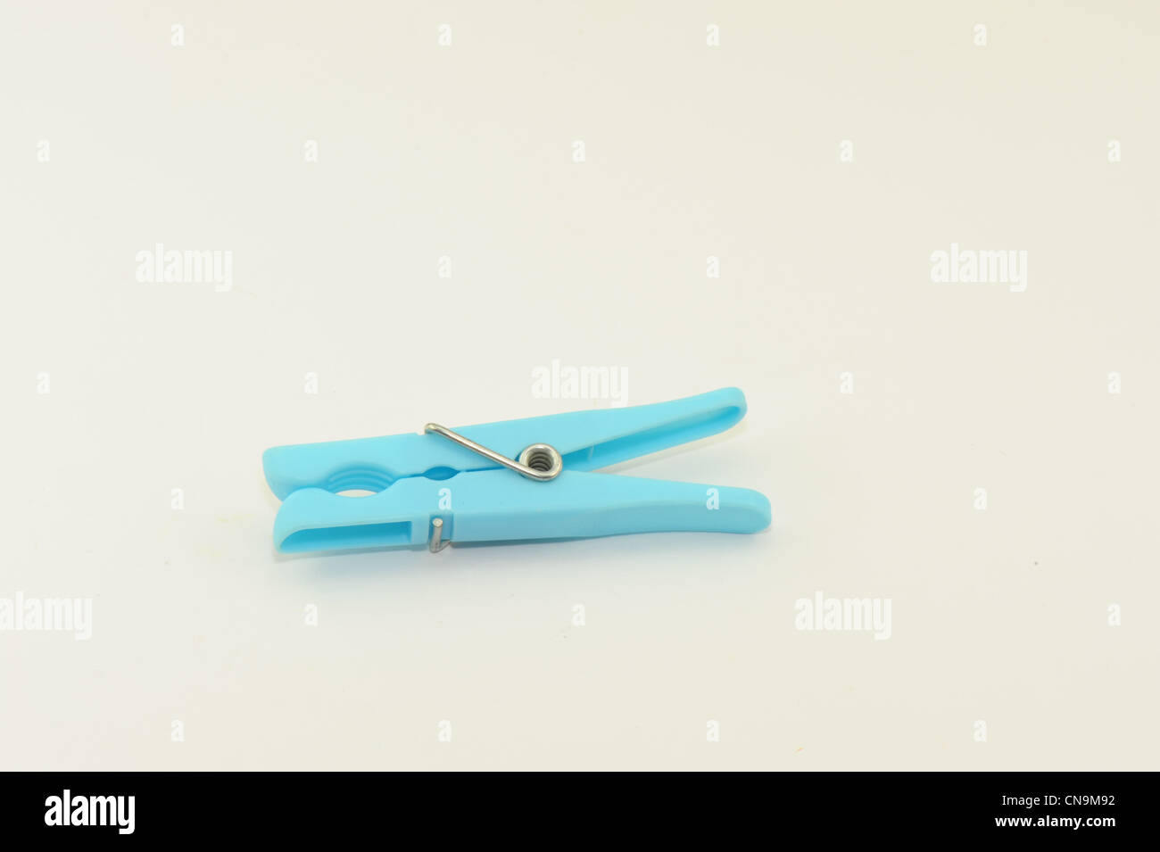clothes peg blue plastic taken on a white background Stock Photo - Alamy