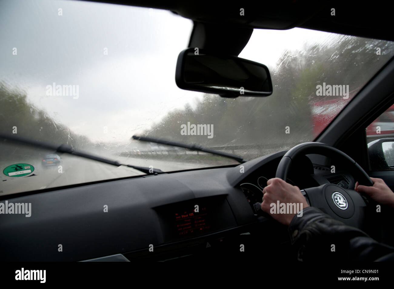 View of A27 and traffic taken through car windscreen during a shower of ...