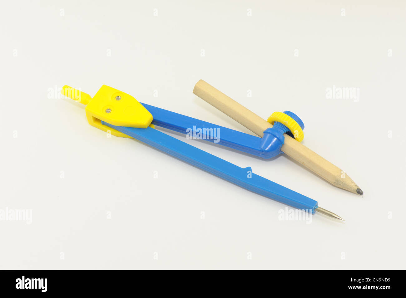 compass with pencil blue yellow plastic taken on a white background ...