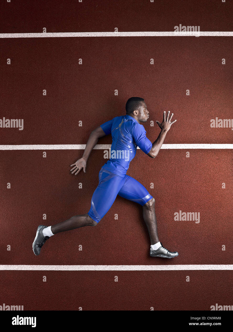 Runner laying on track Stock Photo - Alamy