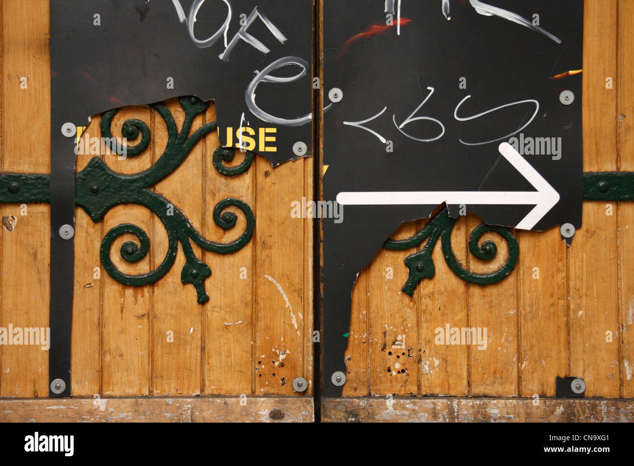 Wooden door covered with a broken sign Stock Photo - Alamy