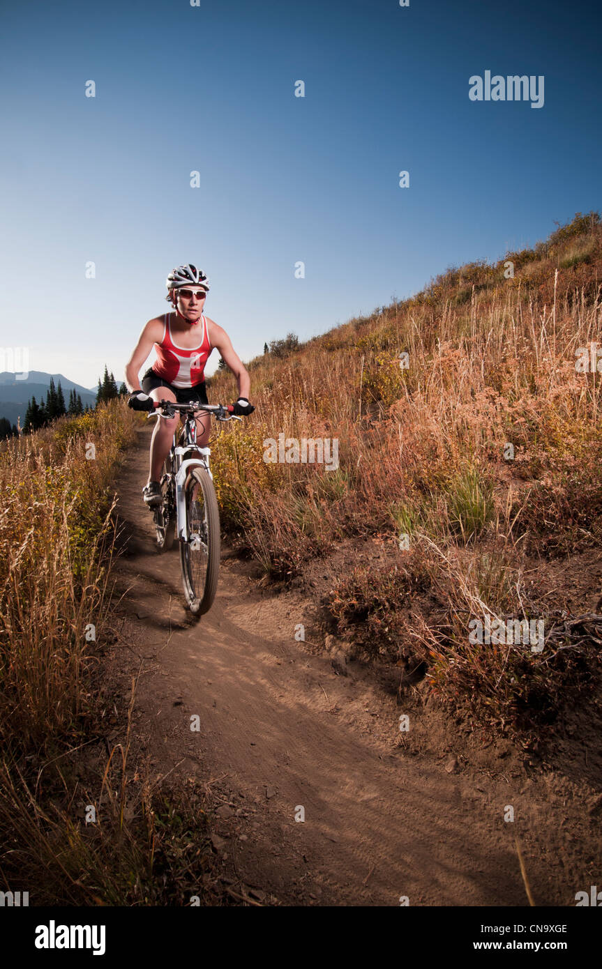 Mountain biker on dirt path Stock Photo - Alamy