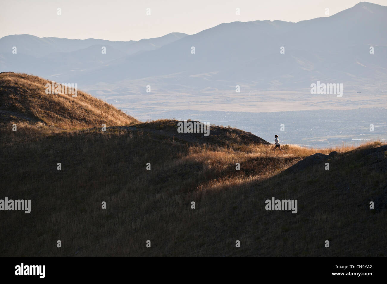 Woman running on dirt path Stock Photo - Alamy