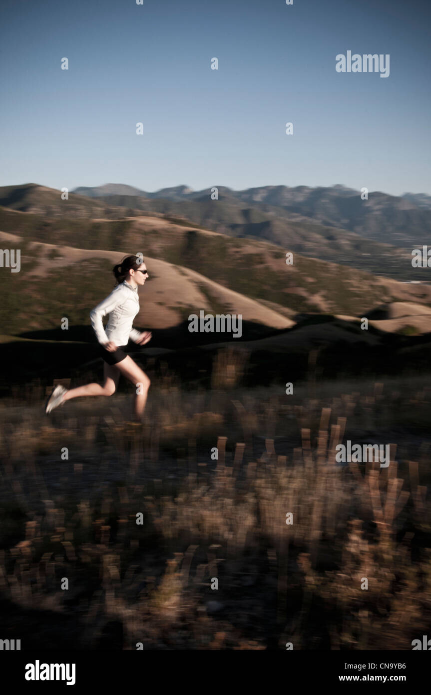 Woman running on dirt path Stock Photo - Alamy