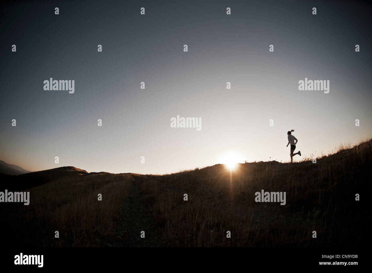 Woman running on dirt path Stock Photo - Alamy
