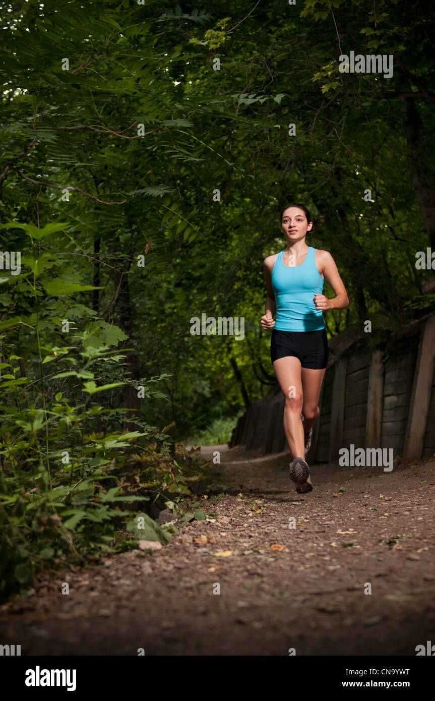 Woman running on dirt path Stock Photo - Alamy