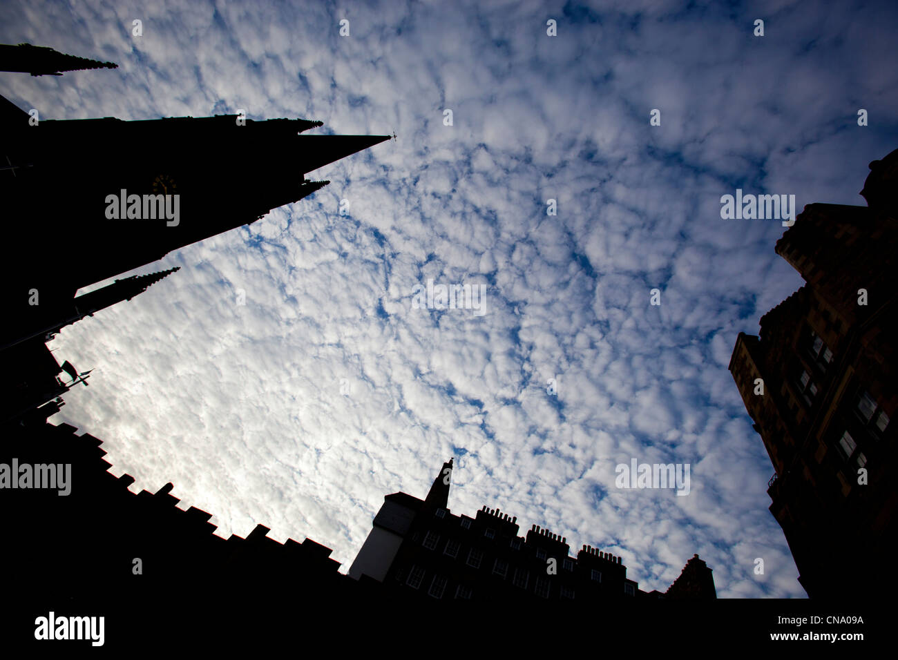 Silhouetted buildings with a dynamic sky taken from a low angle in ...