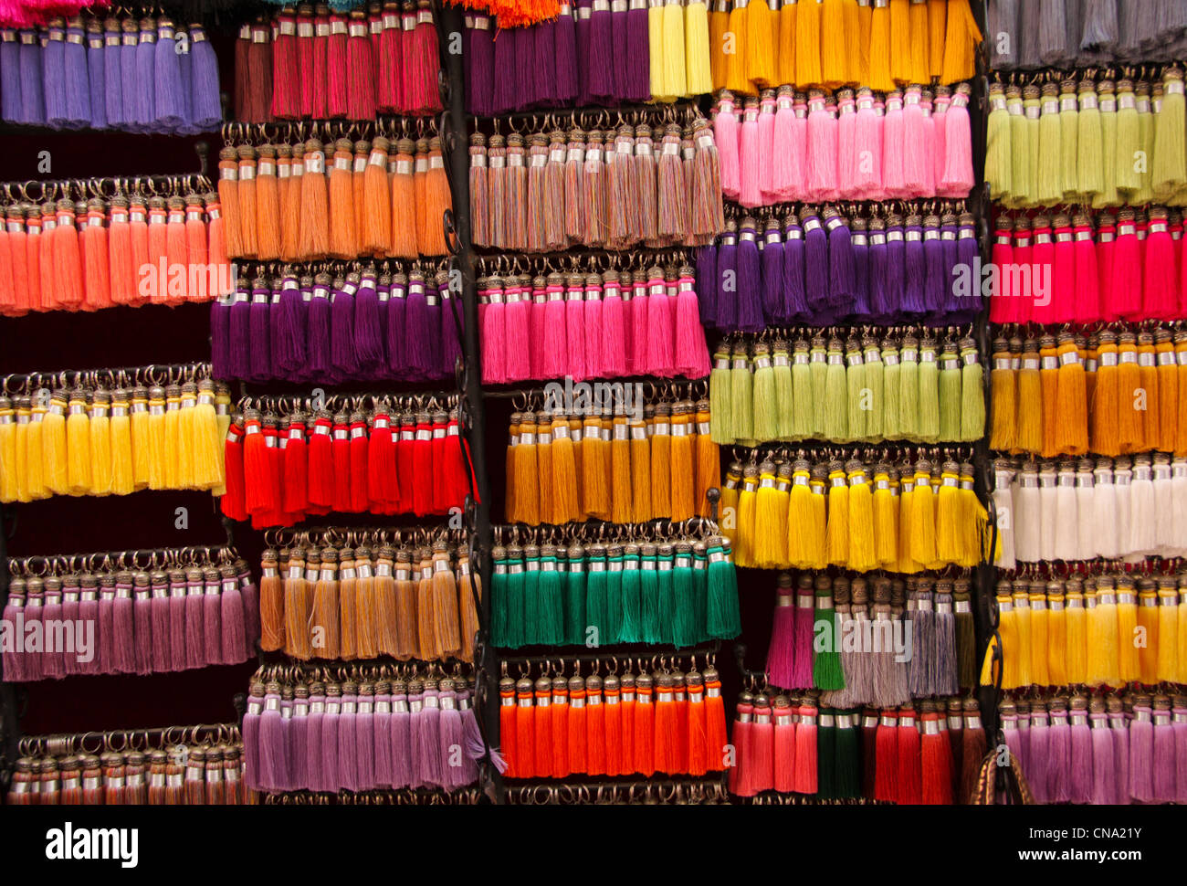 Colourful silk tassels hang for sale in a haberdashery souq, Marrakech ...