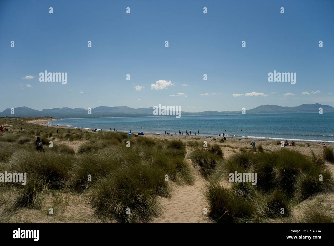 The beach at Traeth Llanddwyn looking towards the Snowdonia hills on ...