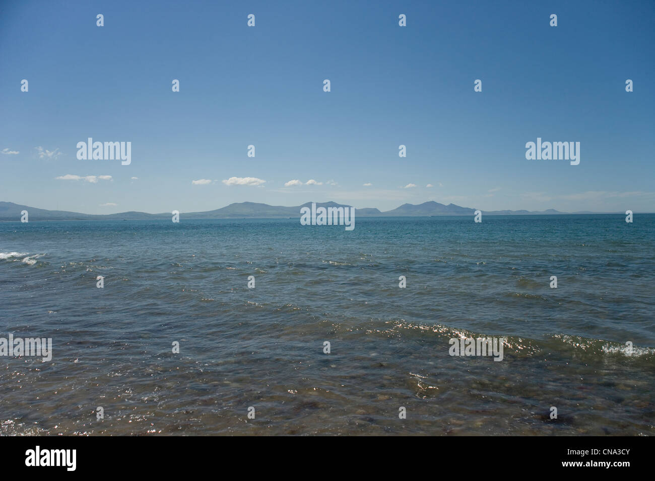 The beach at Traeth Llanddwyn looking towards the Snowdonia hills on ...