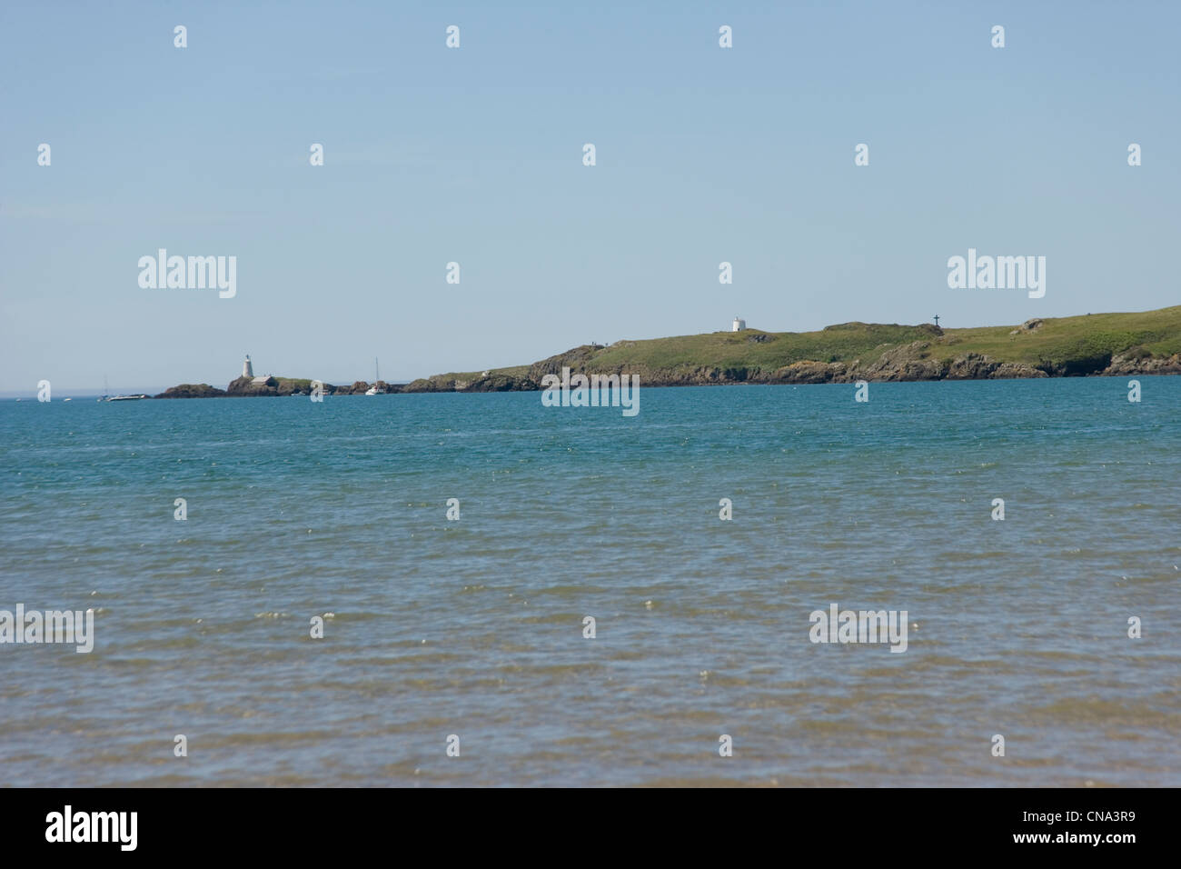 Llanddwyn island and lighthouse from the beach at Traeth Llanddwyn on ...